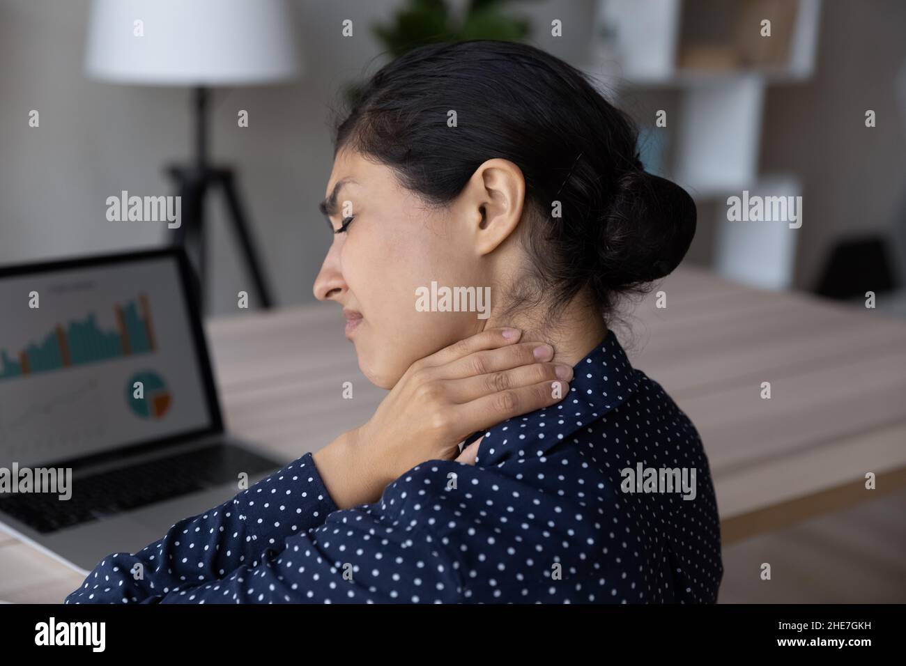 Sad unhappy Indian employee feeling strong neck ache Stock Photo - Alamy