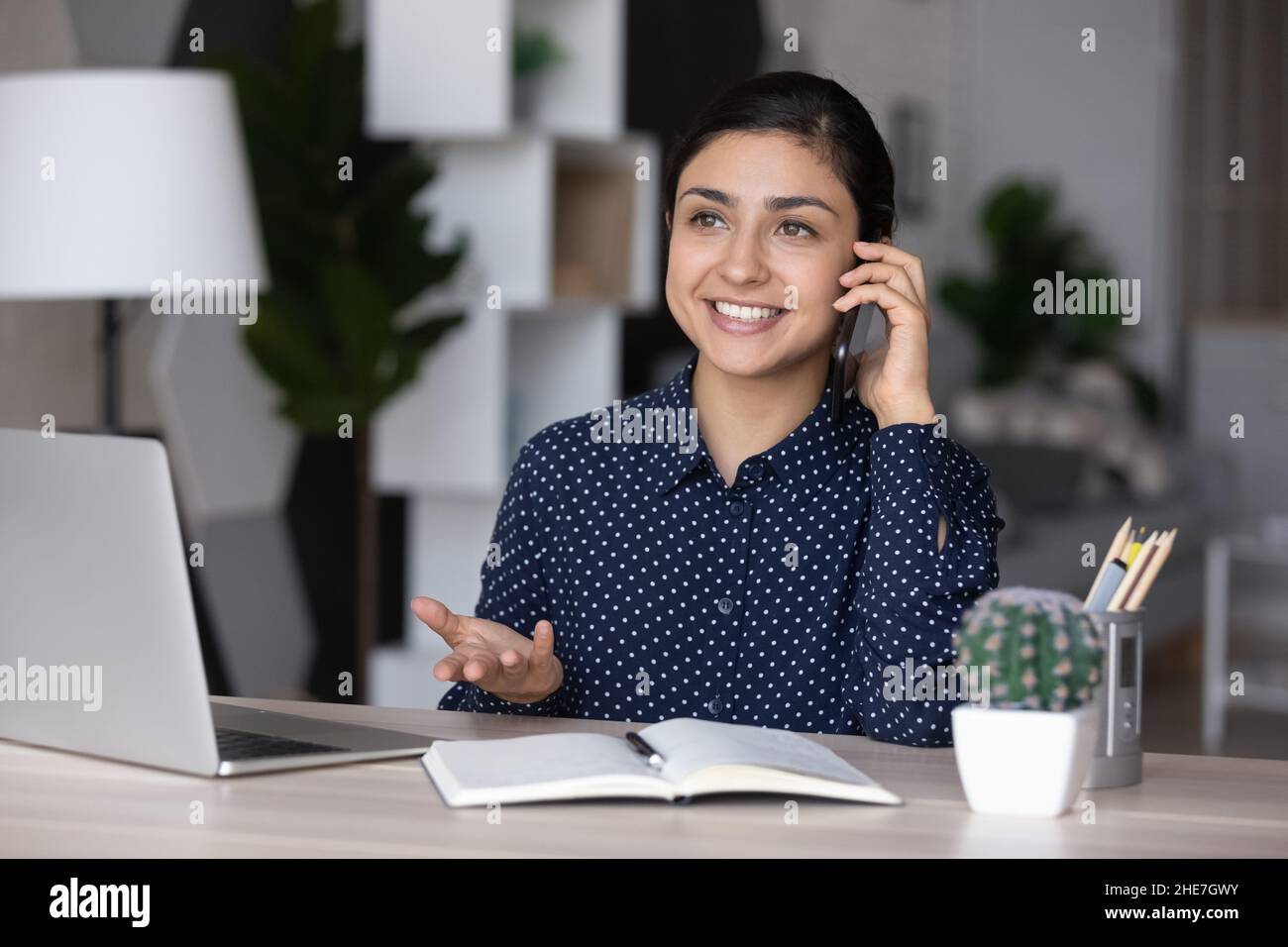 Happy Indian office worker talking on mobile phone Stock Photo - Alamy