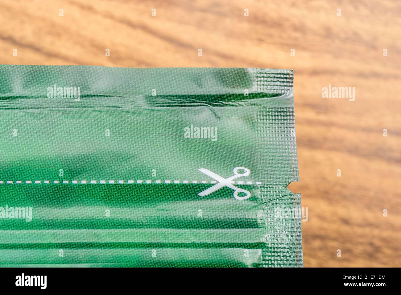 Close-shot of white scissors symbol and dotted cutting line on the ...