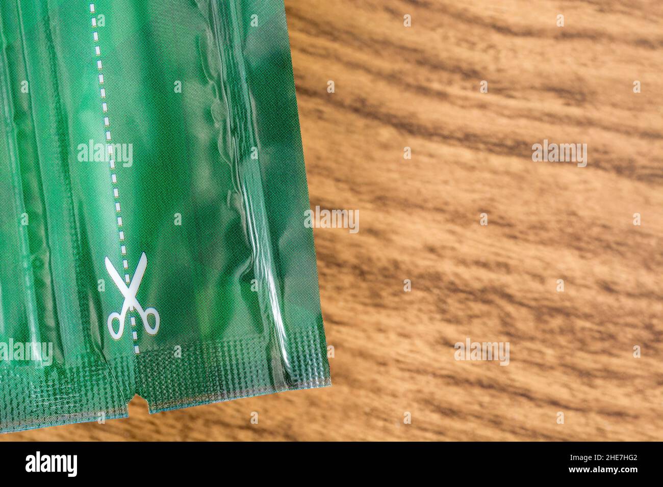 Close-shot of white scissors symbol and dotted cutting line on the ...