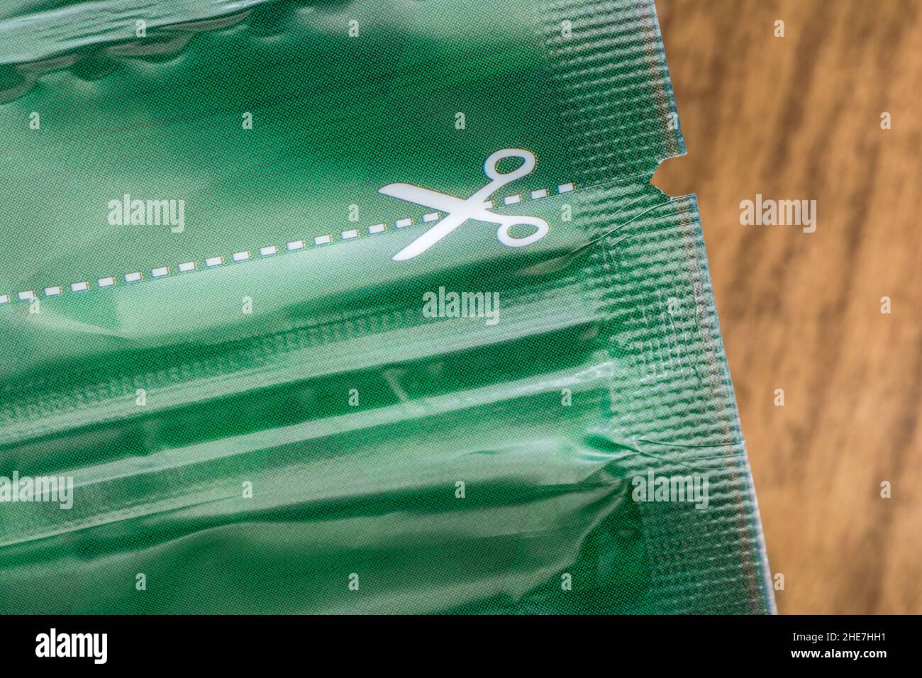 Macro shot of white scissors symbol and dotted cutting line on the ...