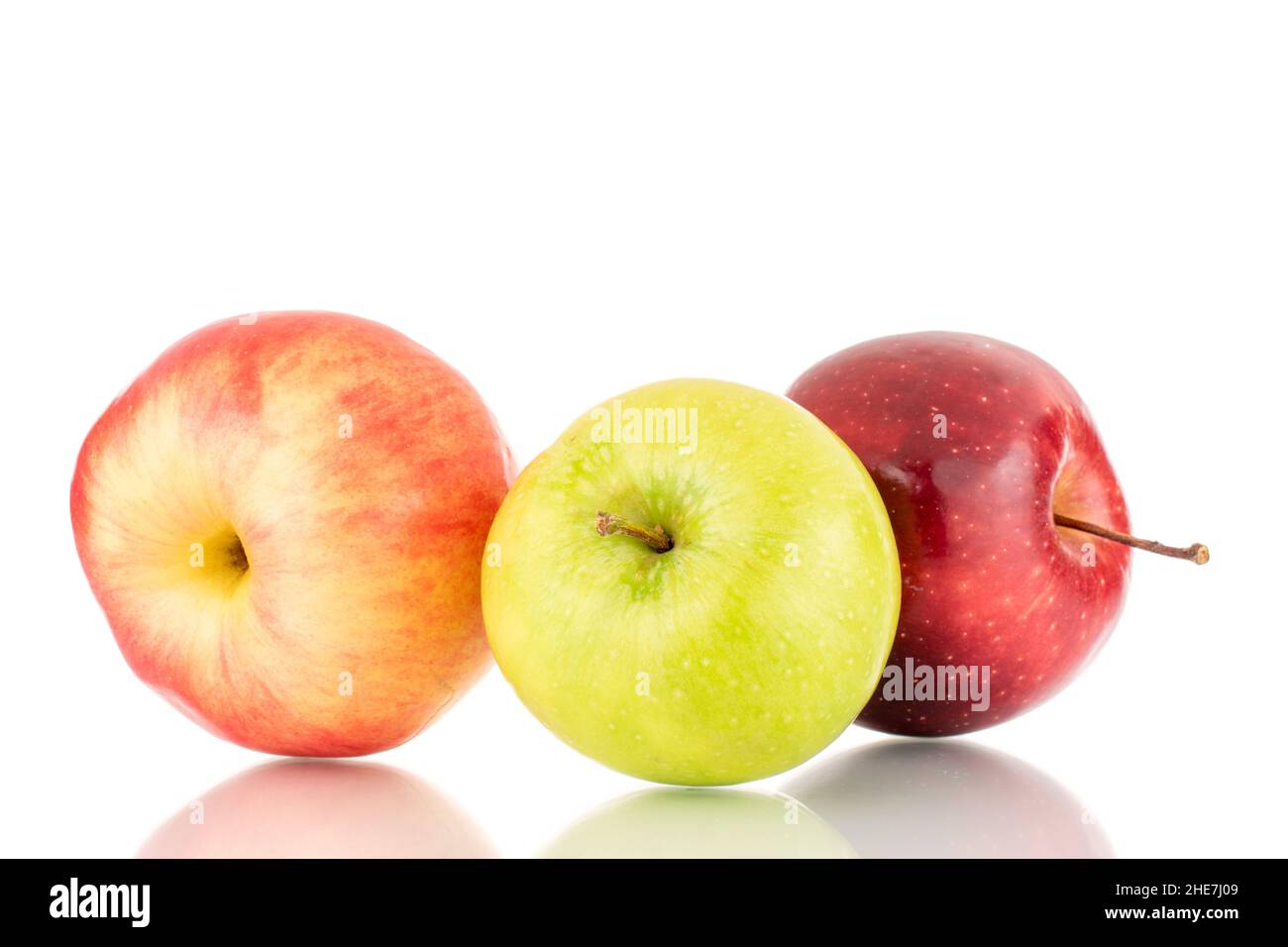 Three juicy apples, green and two red, close-up, isolated on white ...