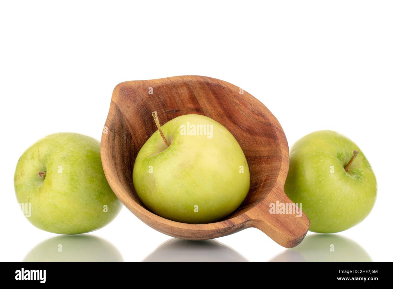 Three sweet green apples with a wooden cup, close-up, isolated on white ...