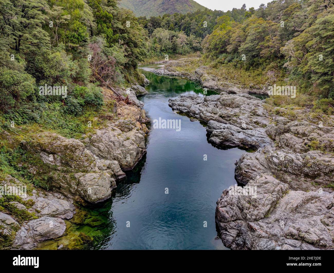 Scenic top view of a tranquil river flowing through the rocks and ...