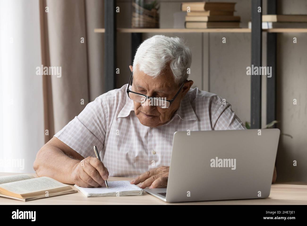 Concentrated old man studying on online courses Stock Photo - Alamy