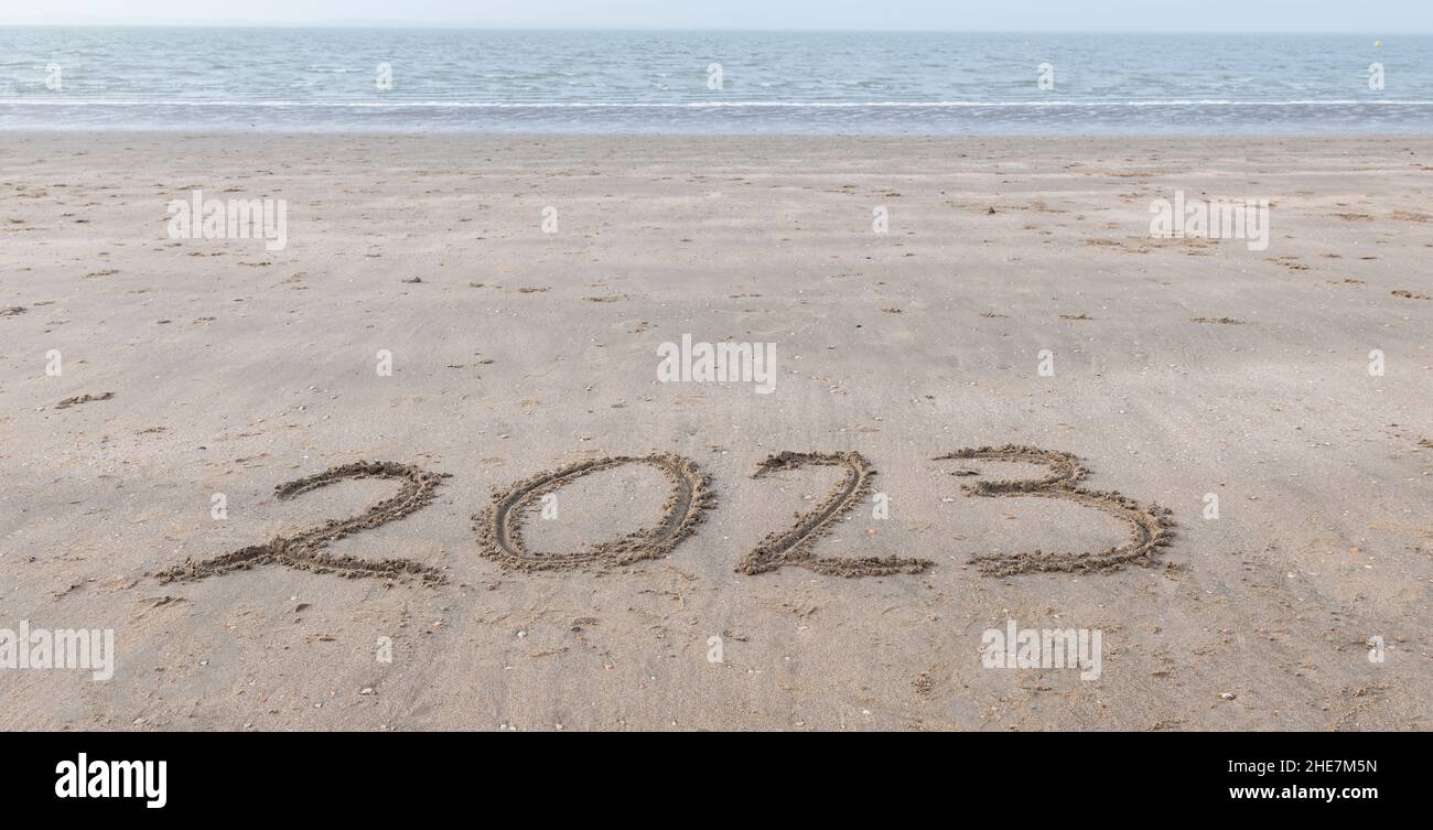 the text 2023 written in the sand on the beach Stock Photo - Alamy