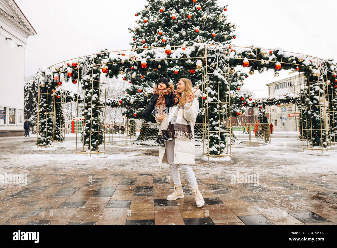 mother and son are having fun, hugging while walking on Christmas in ...