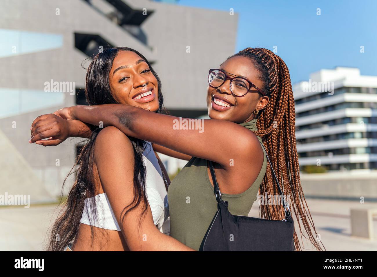 two happy young friends embrace each other in the city, concept of ...