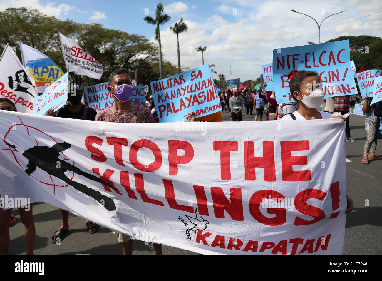 Protesters carry signs during a protest to mark the 73rd International ...