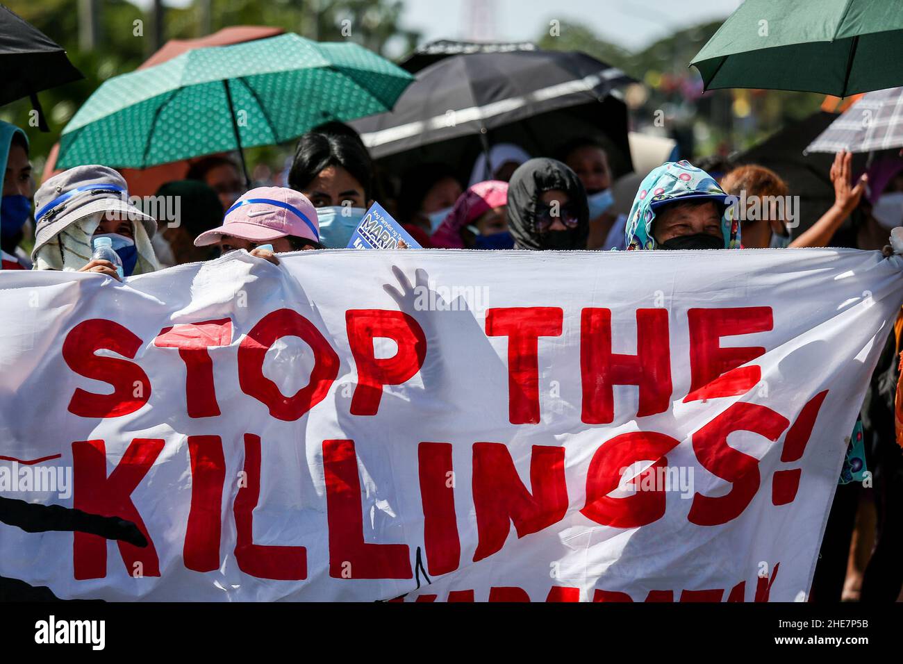 Protesters carry signs during a protest to mark the 73rd International ...