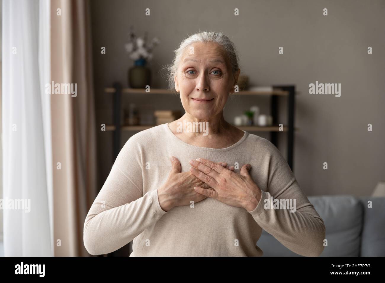 Hands folded to chest hi-res stock photography and images - Alamy
