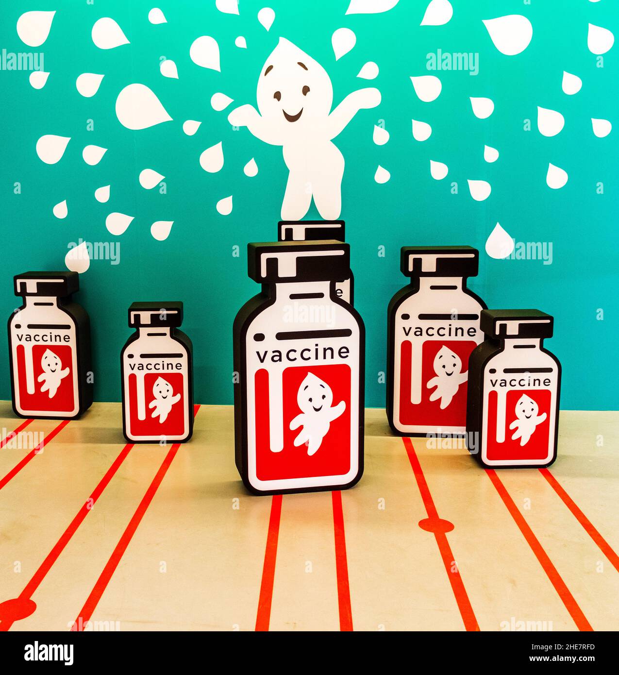 Illustration of cartoon character and vaccine bottles Stock Photo - Alamy