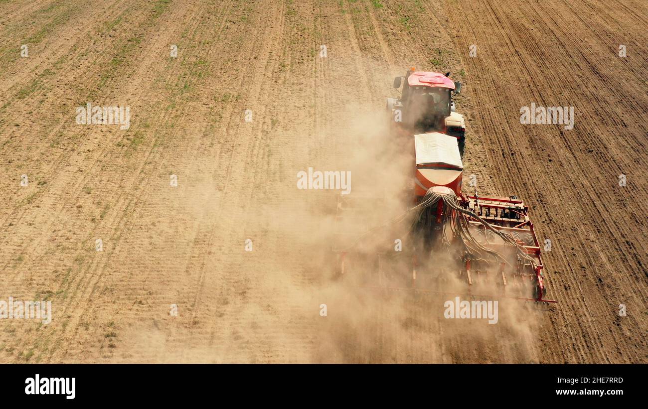 4K Elevated View Tractor With Seed Drill Machine Sowing The Seeds For ...