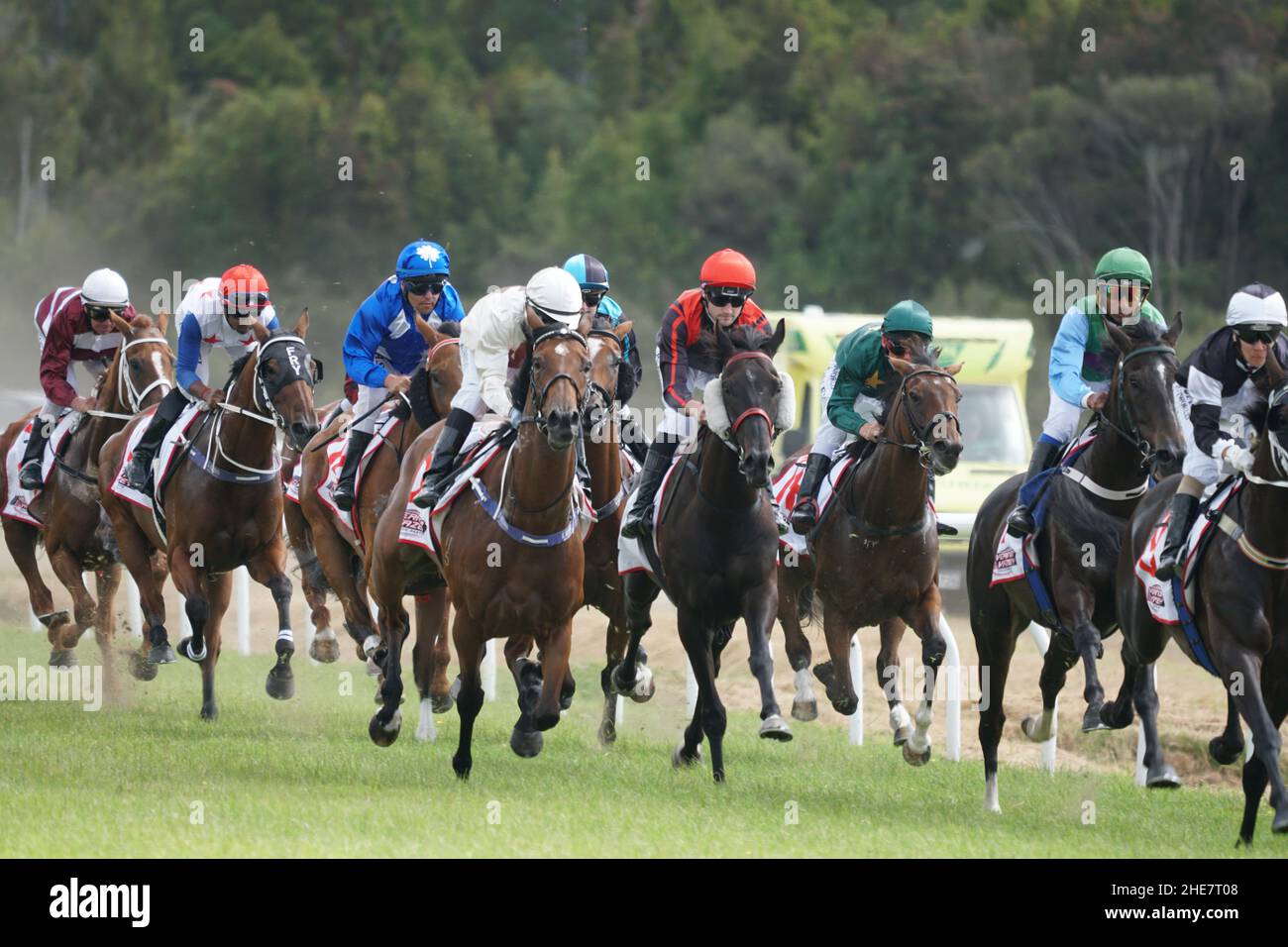 KUMARA, NEW ZEALAND, JANUARY 8, 2022; jockeys ride their mounts hard to the finish line in a ...