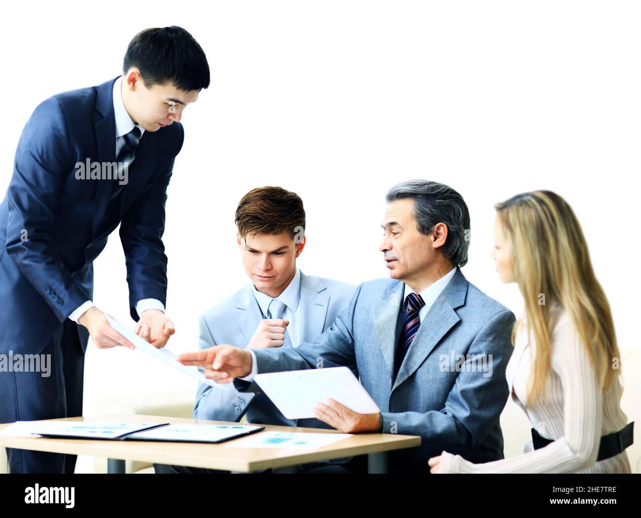 Group of four business people working on laptop at meeting, business ...