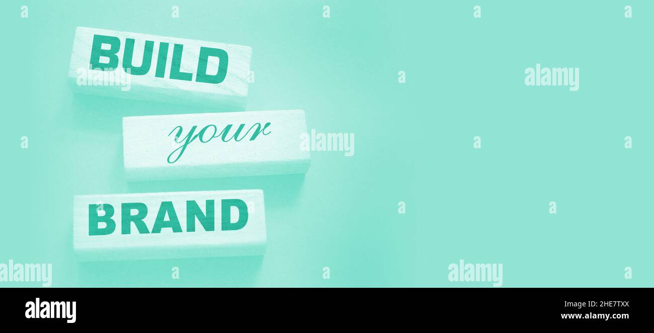 Phrase BUILD YOUR BRAND written on wooden blocks. With vintage styled ...