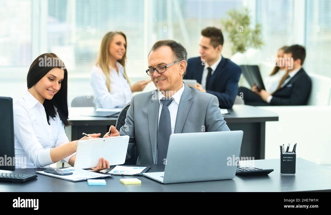 successful businessman and his assistant discuss the work plan of the ...