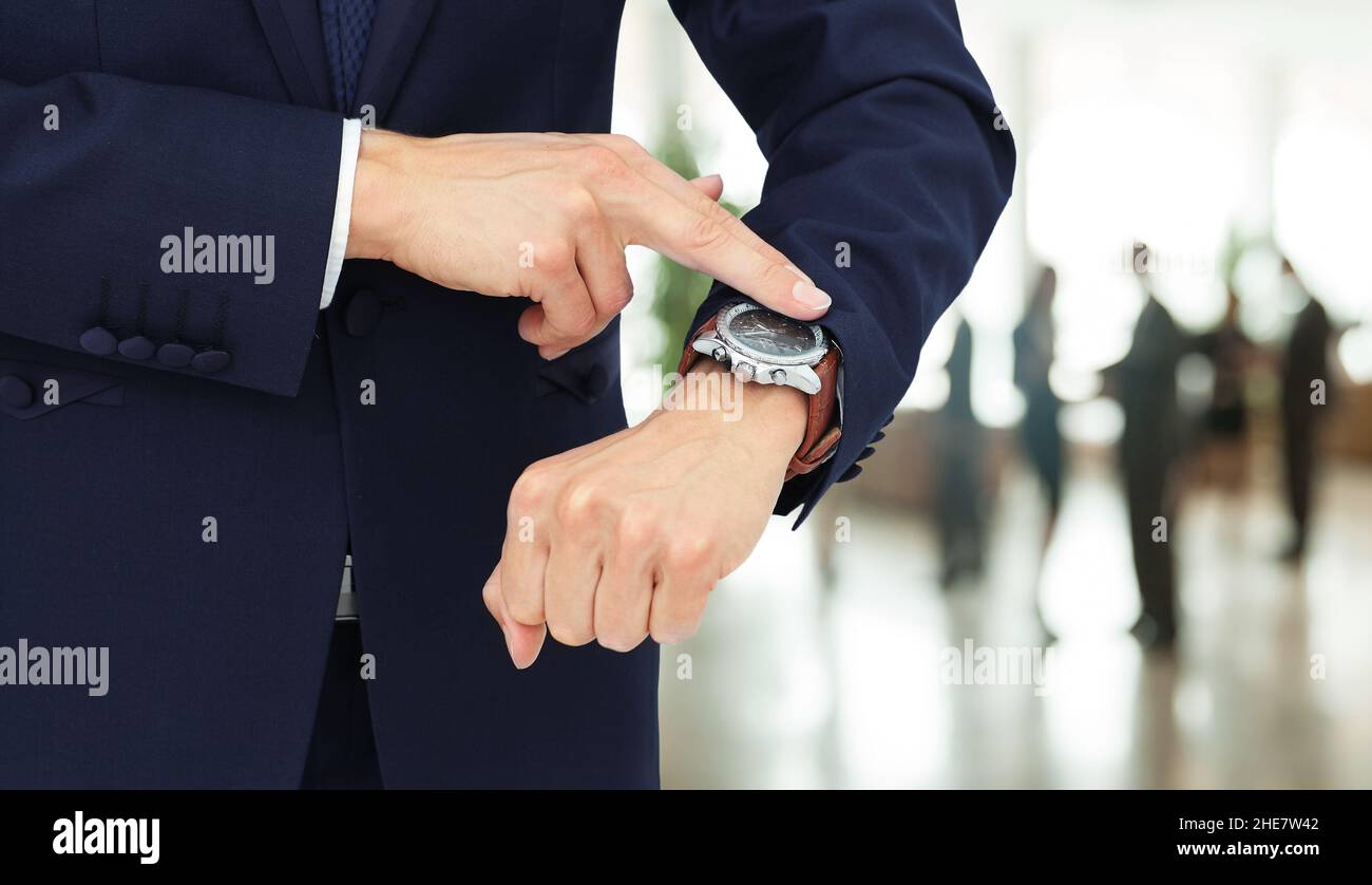 concept of respect for time. businessman pointing his finger at wrist ...