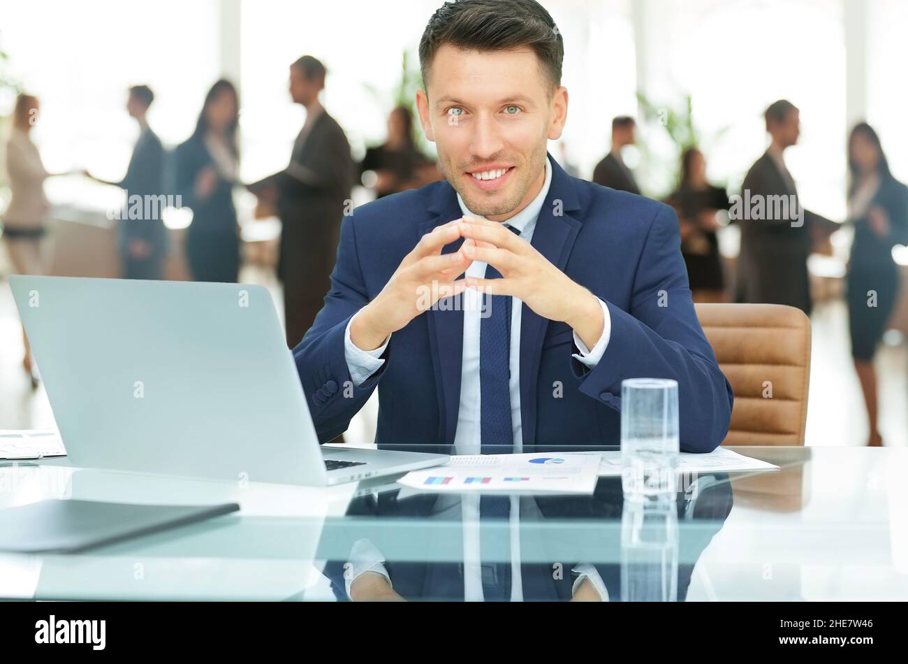 company representative at the Desk on office background Stock Photo - Alamy