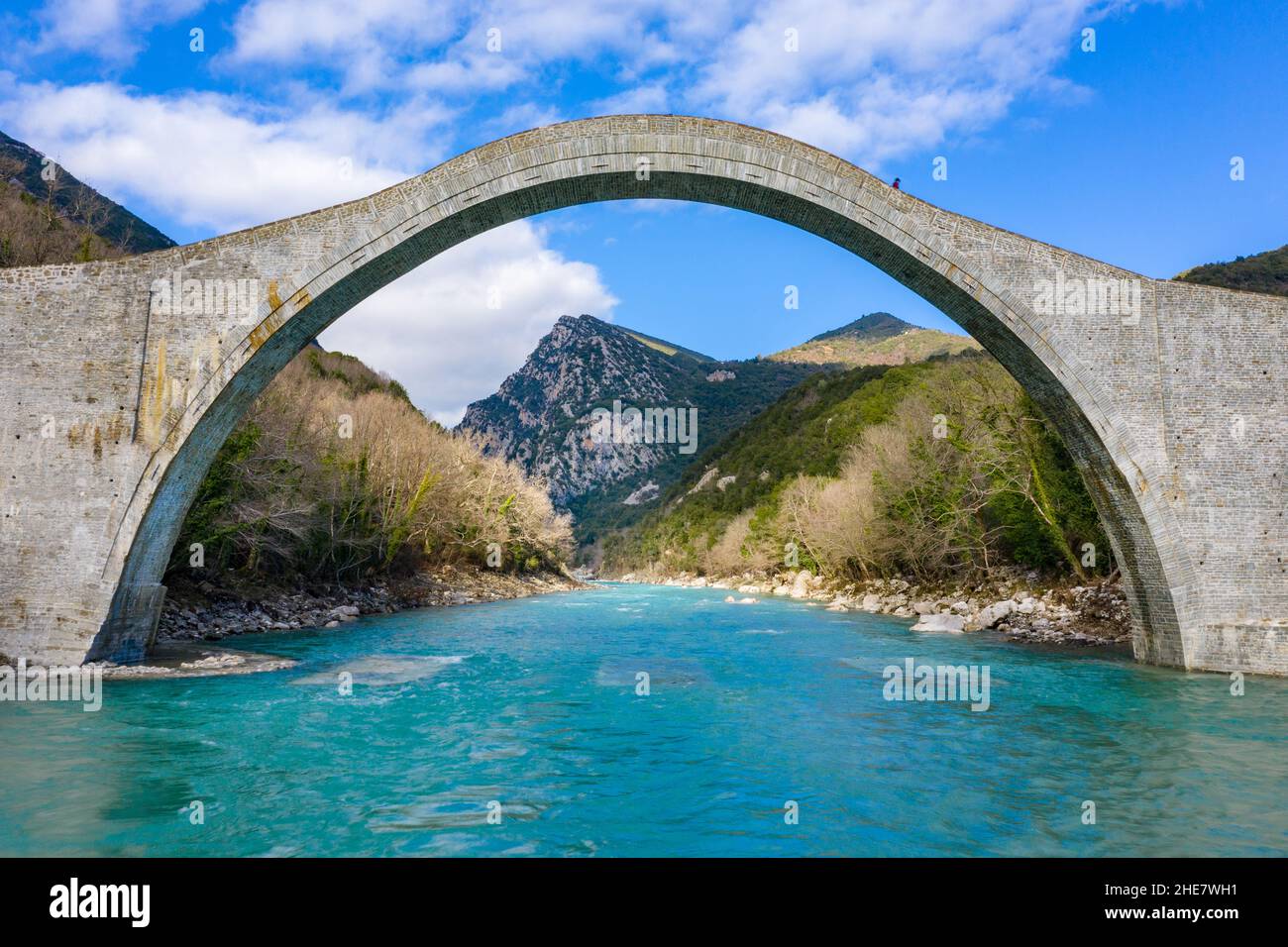 The great arched stone bridge of Plaka on Arachthos river, Tzoumerka ...