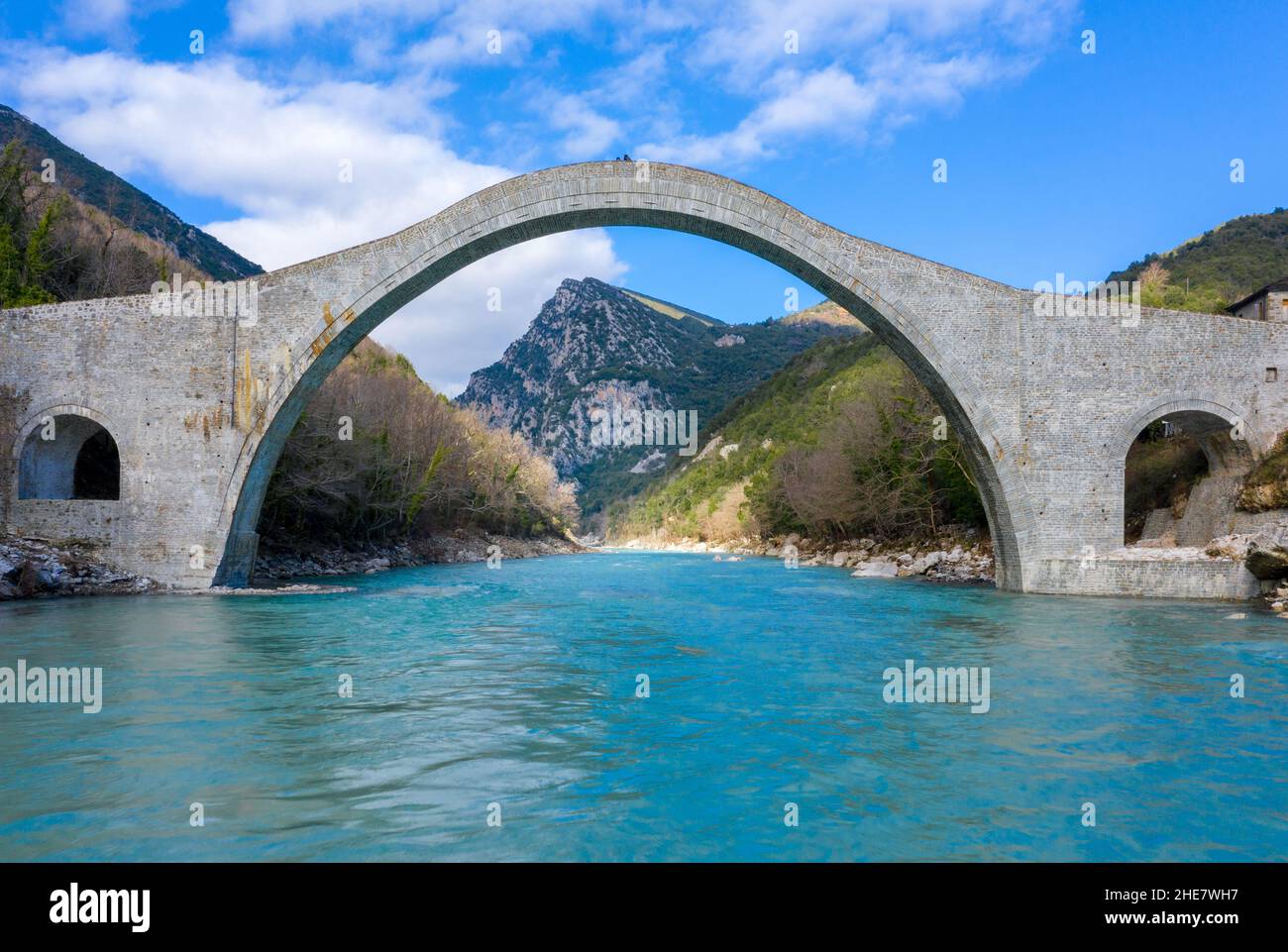 The great arched stone bridge of Plaka on Arachthos river, Tzoumerka ...