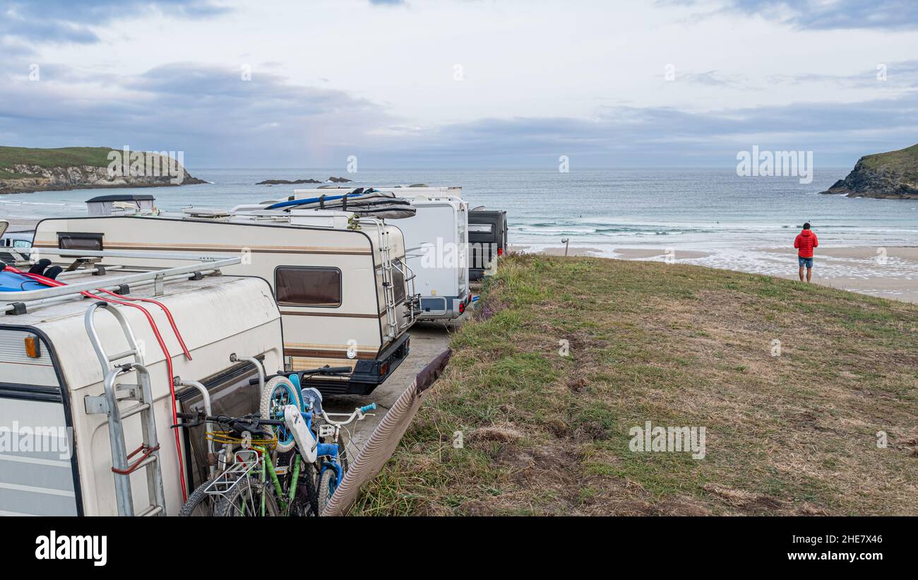 Caravanners on the beach at sunset contemplating the sun Stock Photo ...