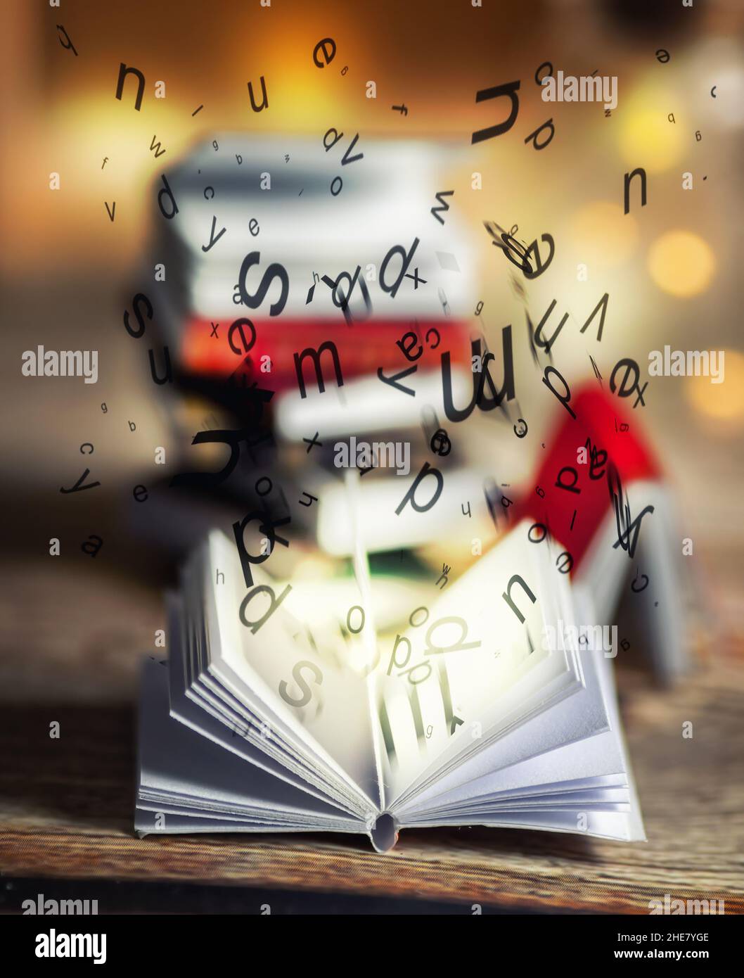 Letters flying out from an open book Stock Photo - Alamy