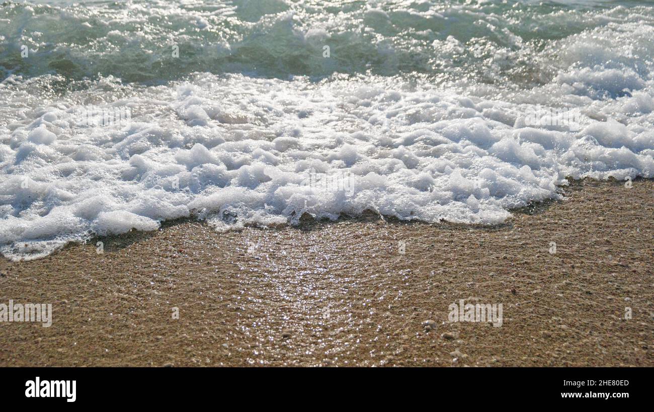 sea surf in the red sea on a sandy beach. wave close-up Stock Photo - Alamy