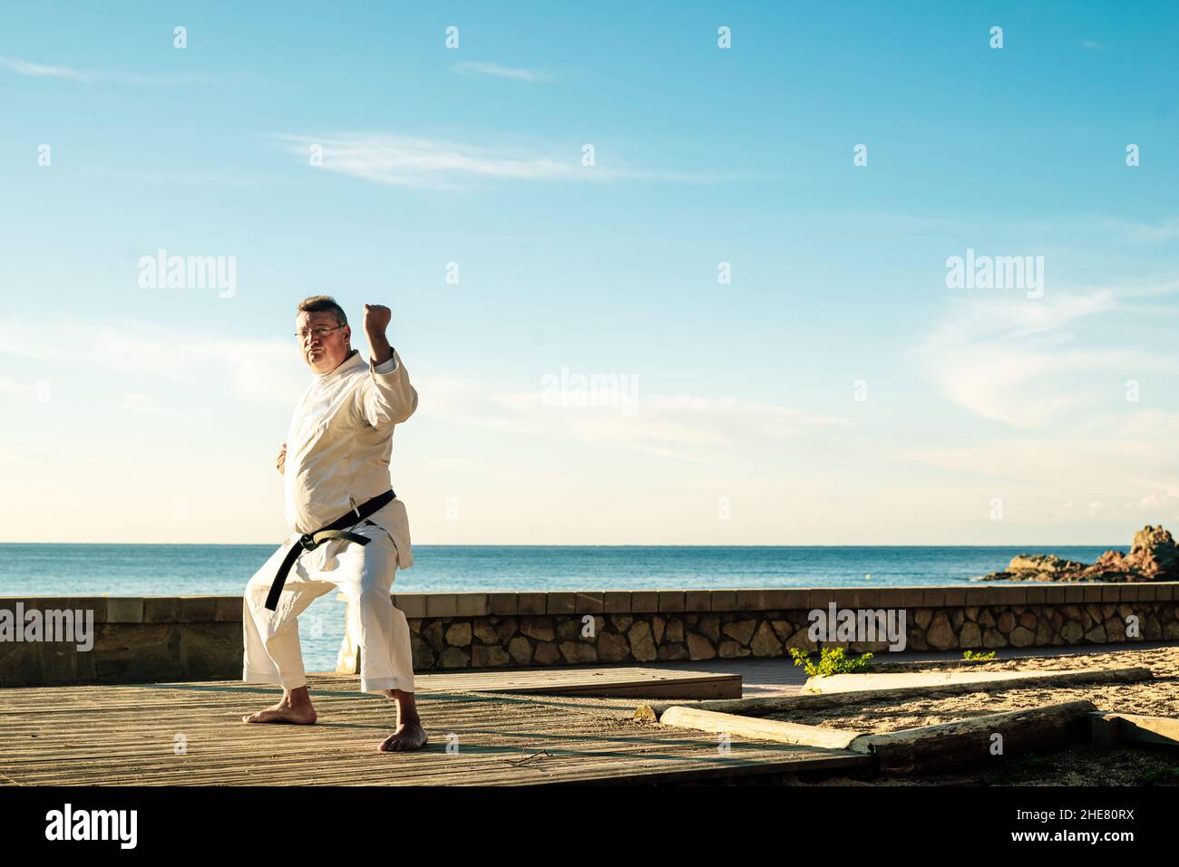 Caucasian forty licensed male with glasses practicing Karate sport ...