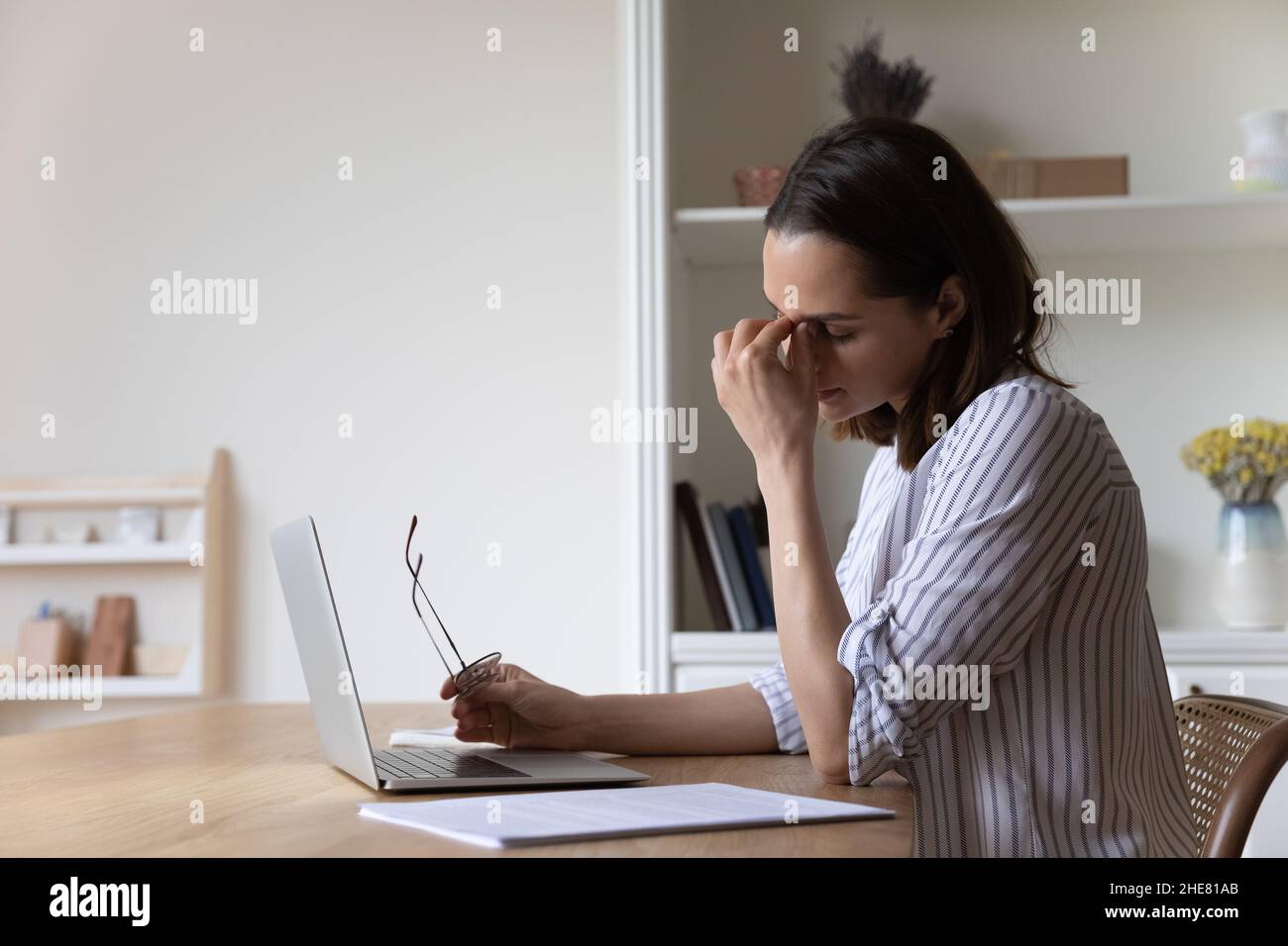 Tired employee woman working at laptop computer too long Stock Photo ...