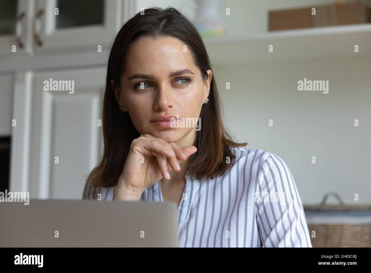 Serious pensive millennial business professional woman distracting from ...