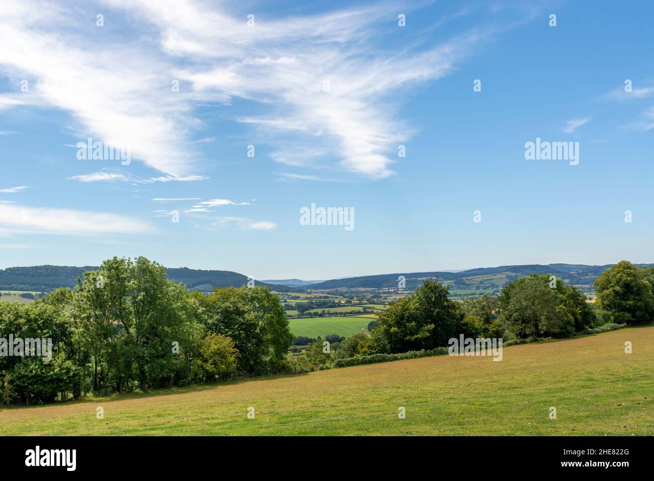 Landscape of colourful english countryside and forests with cirrus ...