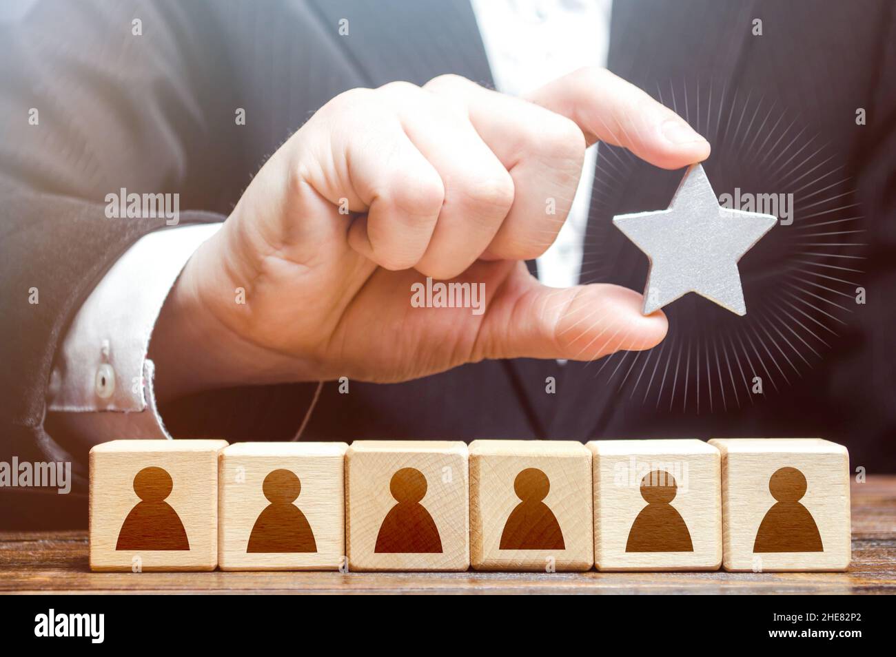 A businessman is holding a star over the team. Awarding. High ...