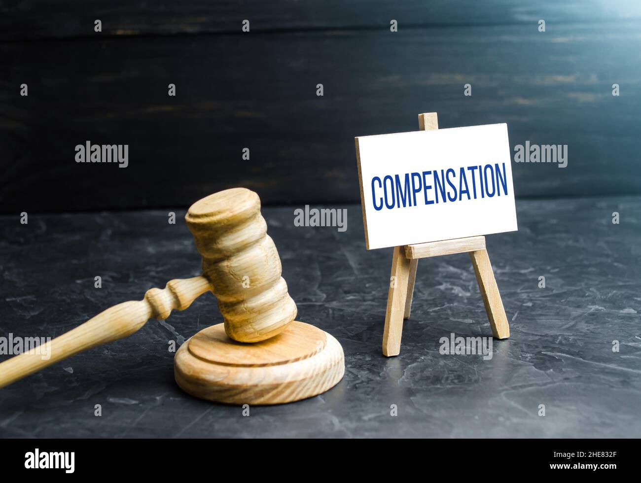 Compensation and judge's gavel. Award of moral financial compensation ...