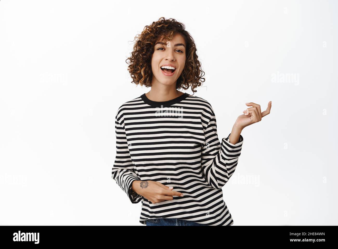 Carefree, happy young middle eastern woman dancing and playing on ...
