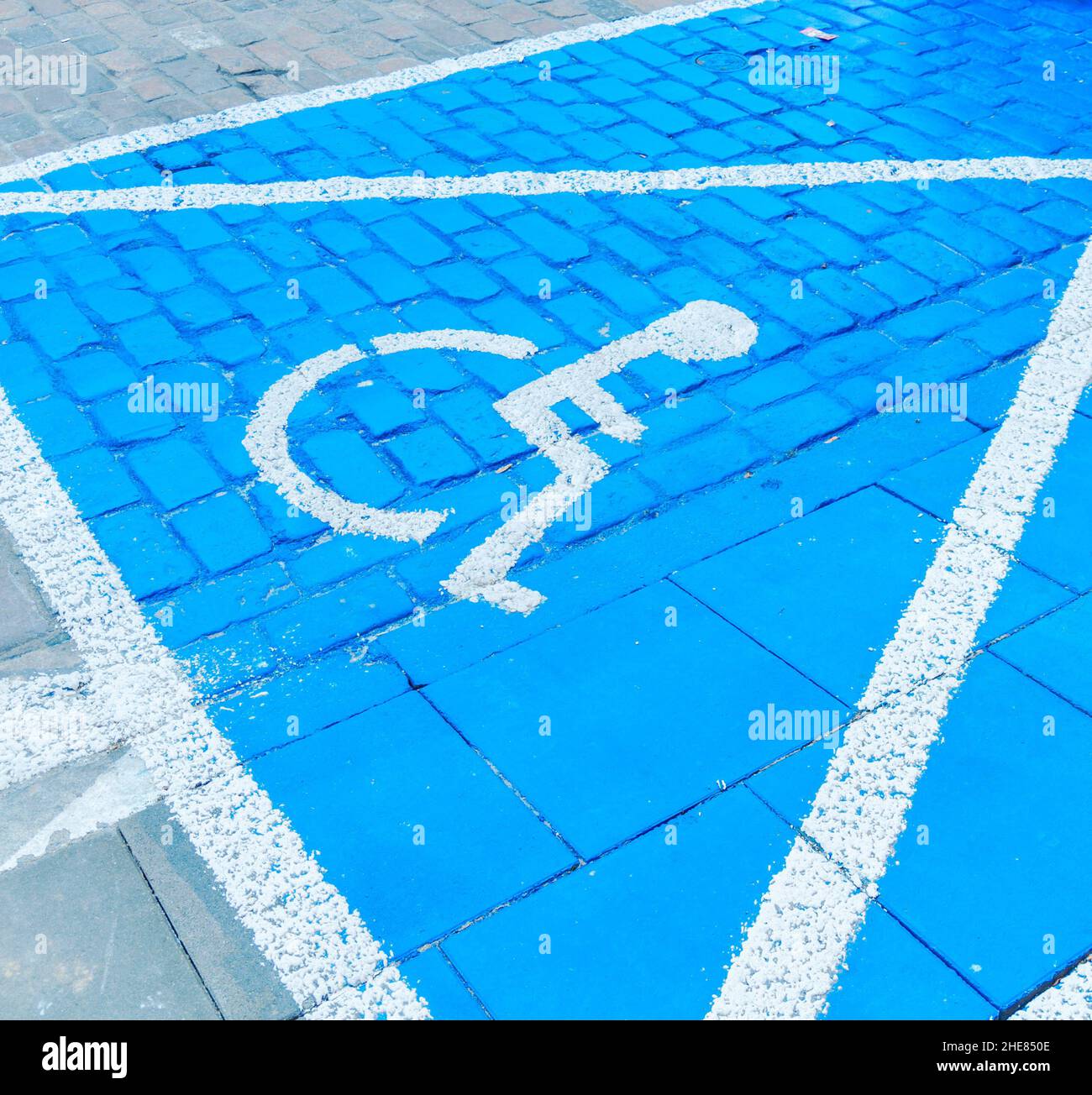 Blue handicap parking sign on asphalt for persons with disabilities ...