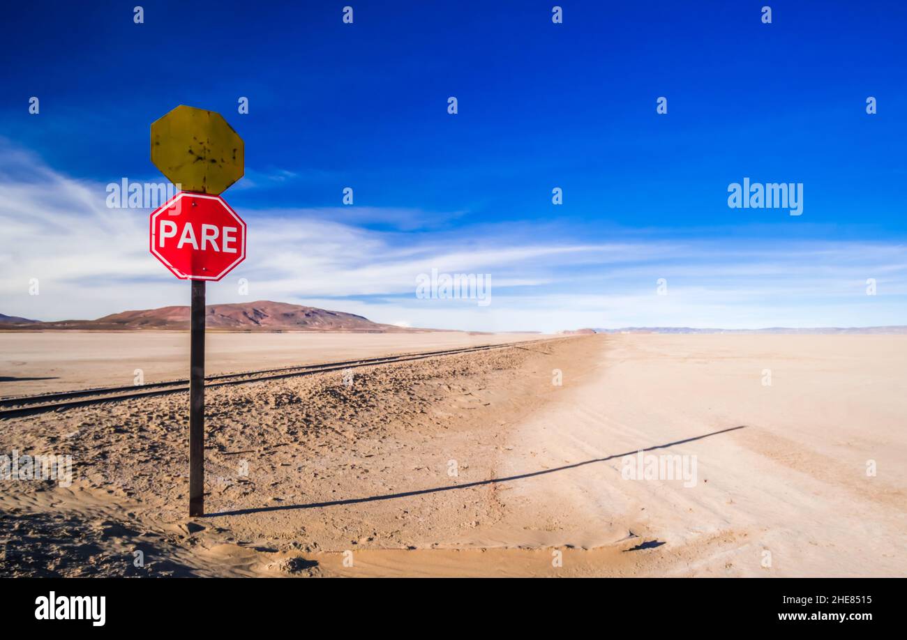 Stop sign next to old railway in Salar de Uyuni salt flat, Bolivia ...