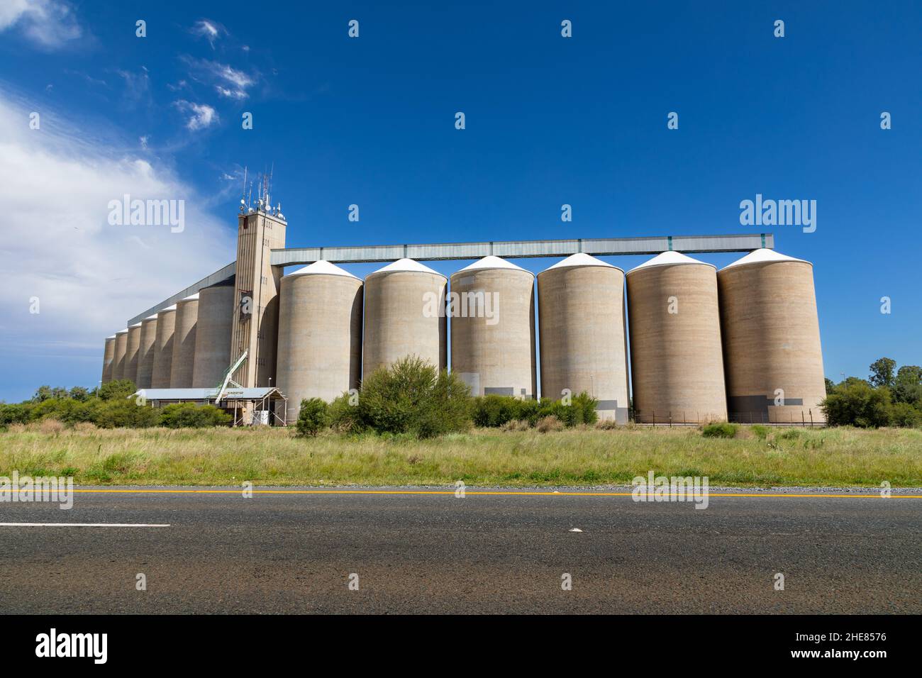 Grain silos in the field with an asphalt road in the foreground Stock ...