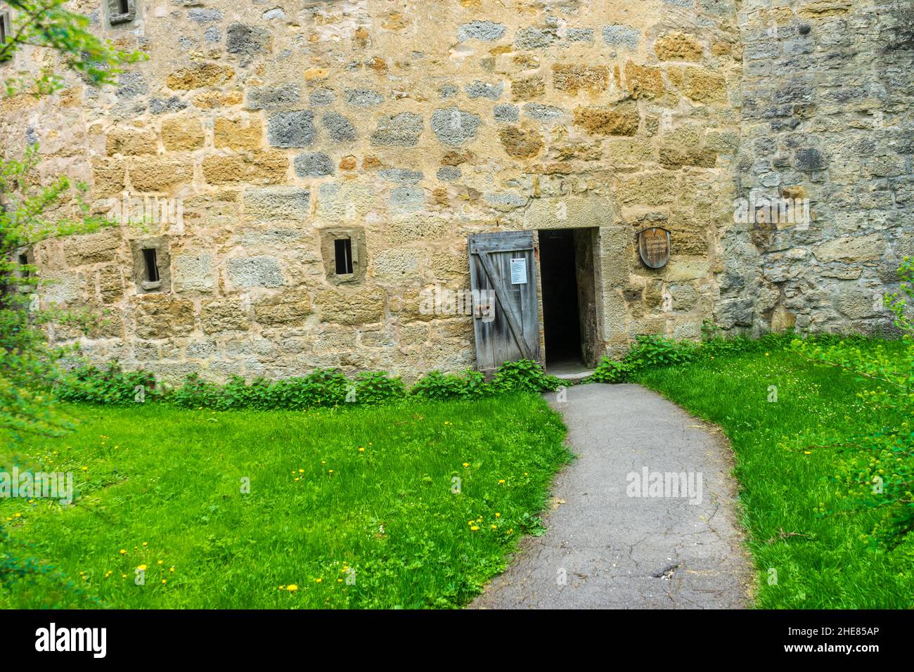 Closeup of a brick wall building with an open door Stock Photo - Alamy