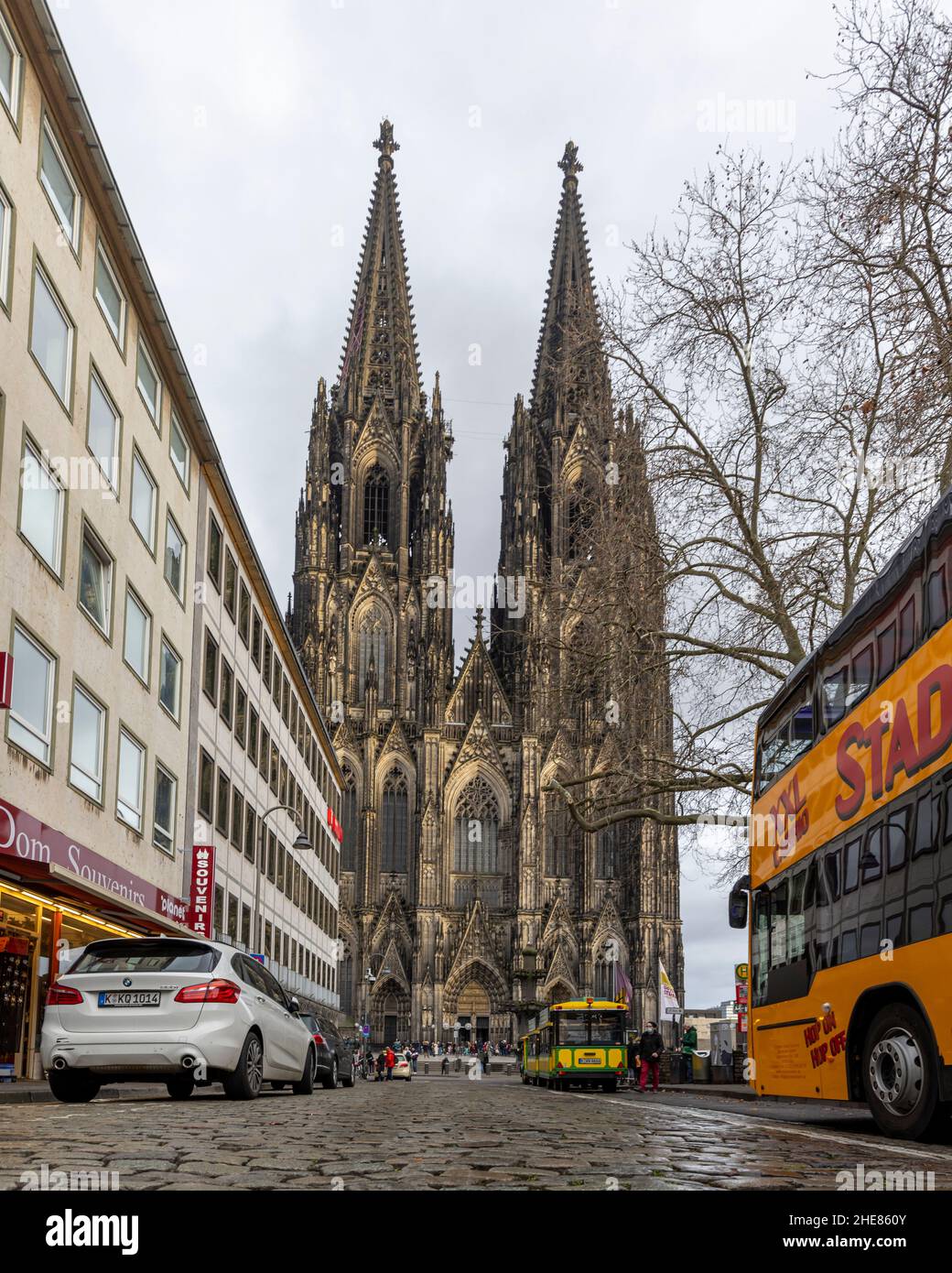 Cologne Cathedral on brisk winter day with tourist walking in front ...