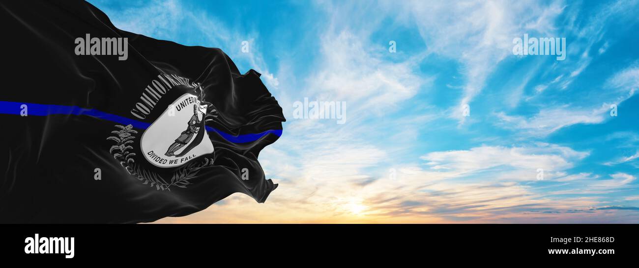 blue line flag of Kentucky state, Usa at cloudy sky background on ...