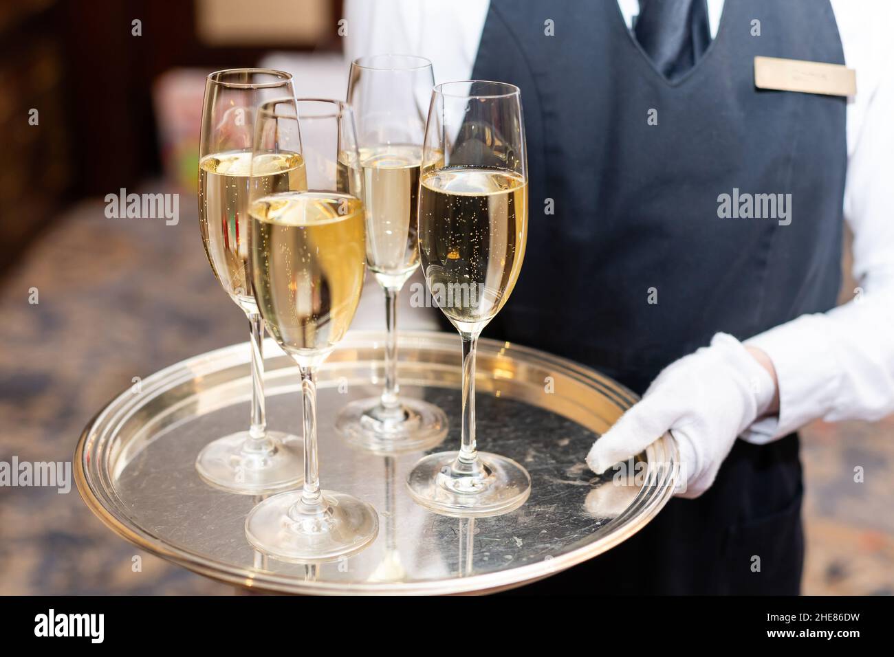 professional waiter in uniform is serving wine Stock Photo - Alamy