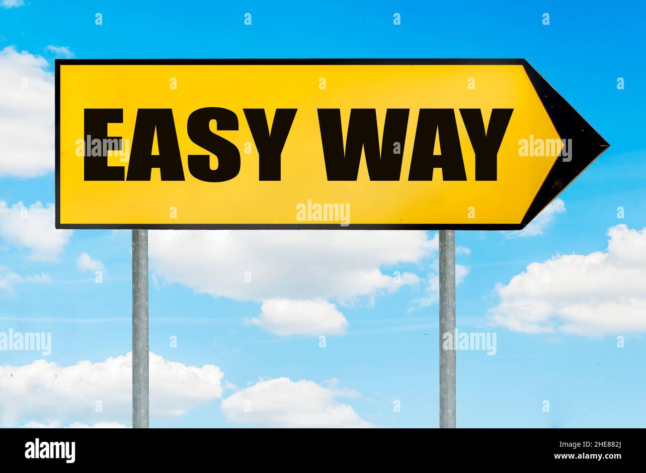 Easy Way Sign -Yellow road sign with arrow pointing right against blue ...