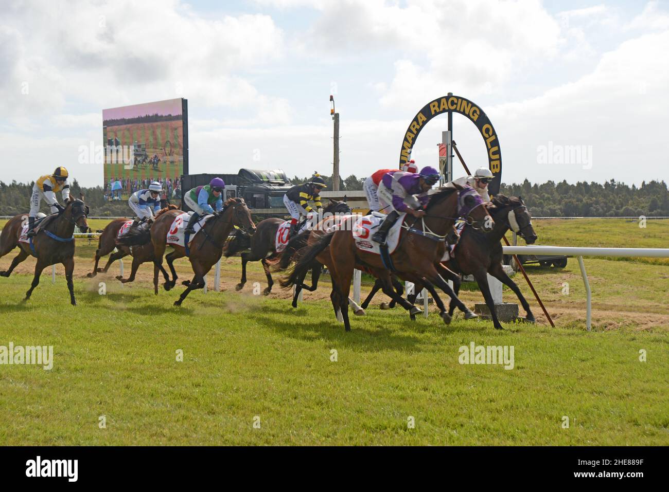 KUMARA, NEW ZEALAND, JANUARY 8, 2022; jockeys ride their mounts hard to the finish line in a ...