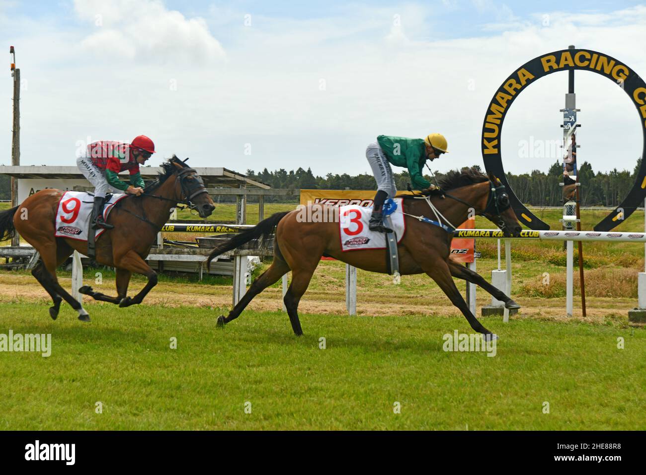 KUMARA, NEW ZEALAND, JANUARY 8, 2022; jockeys ride their mounts hard to the finish line in a ...