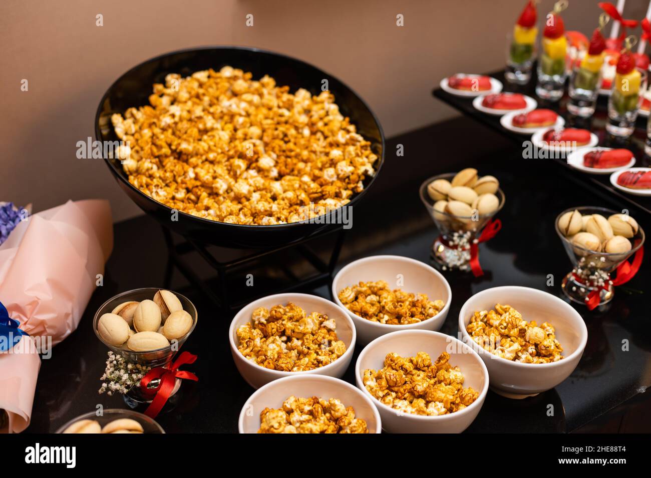 Details of a tasty candy bar with buckets of popcorn and pasteboard ...
