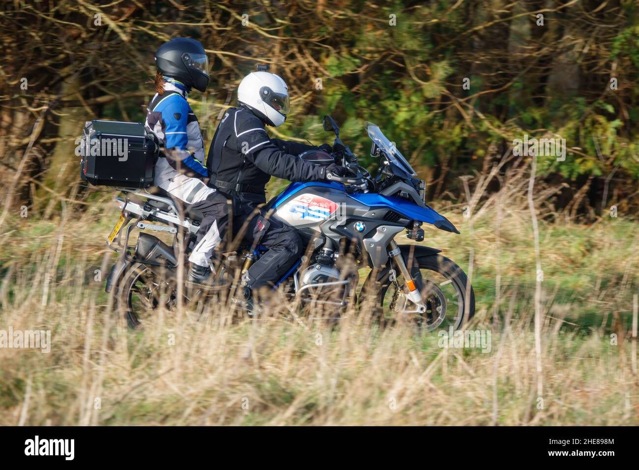 motorbike rider and pillion passenger on a BMW R1200 GS motorcycle ...