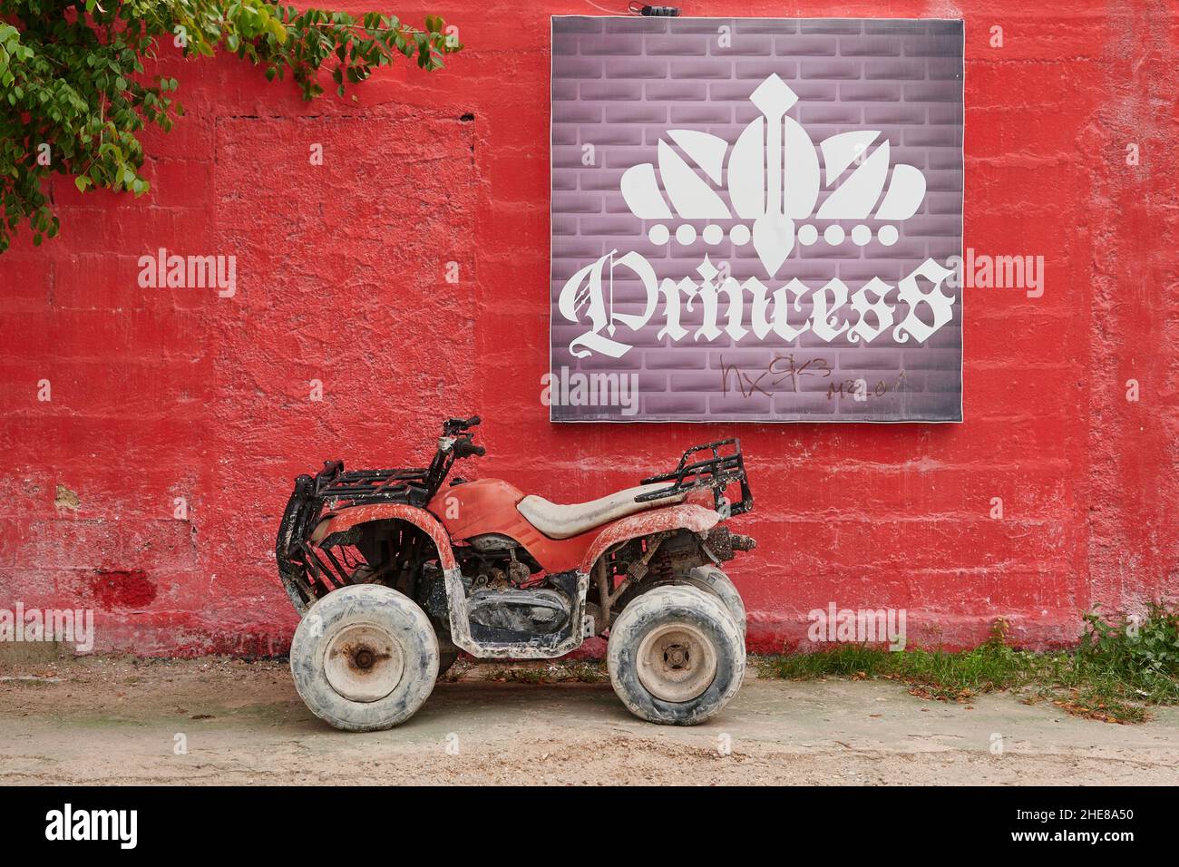 ATV parked in front of building painted with mural Stock Photo - Alamy