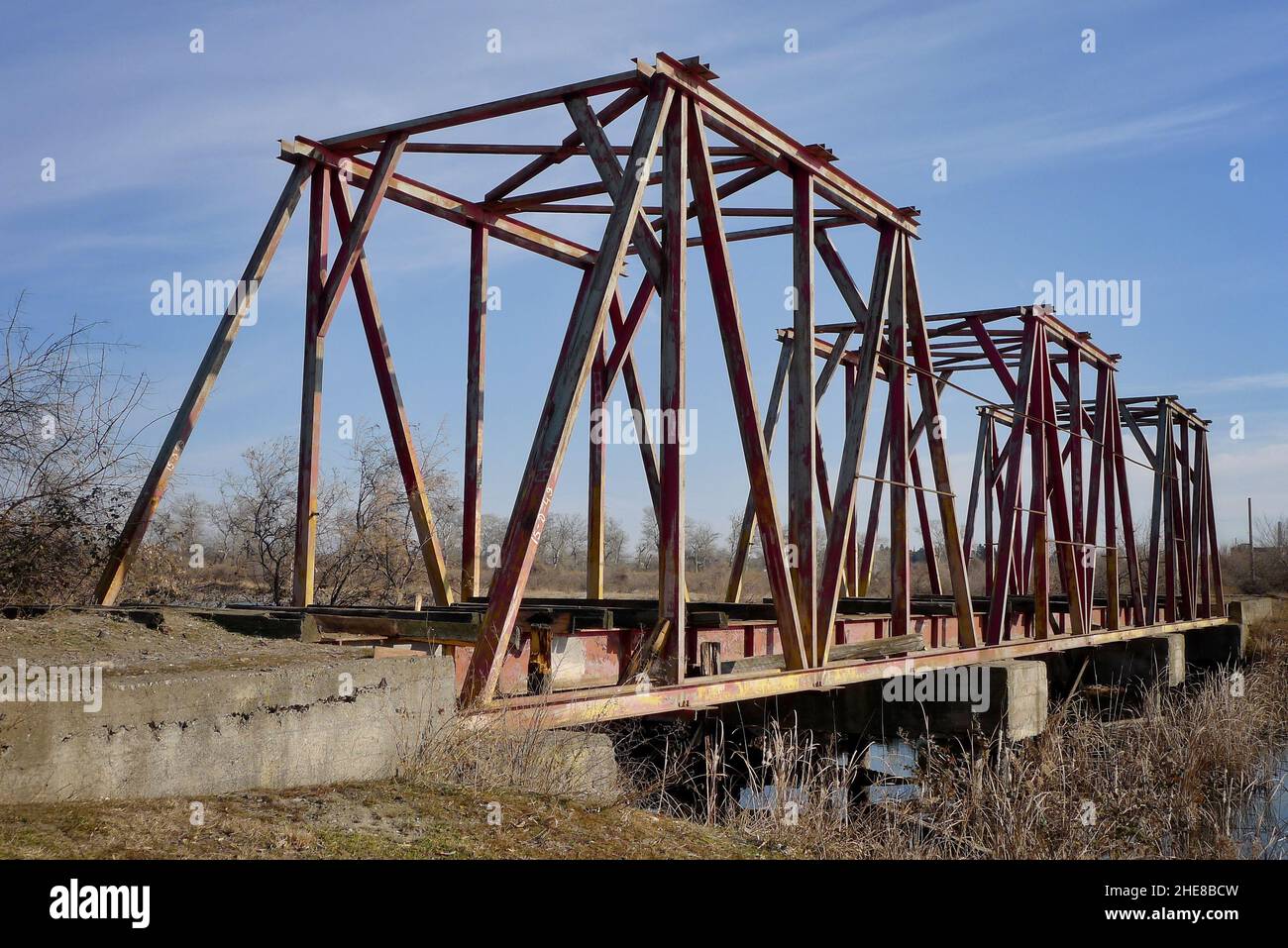 Open metal tunnel on the bridge. Cuckoo railway over the swamp Stock ...