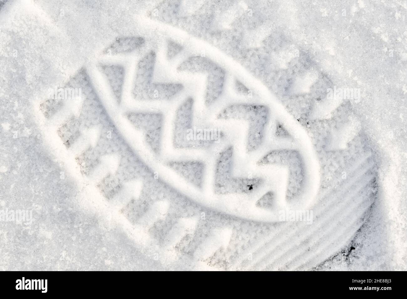 Close-up of a shoe print in the snow, top view of a boot footprint ...